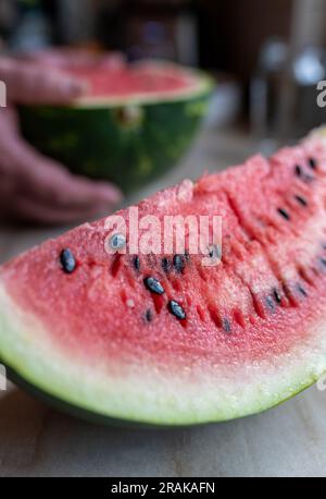 Fresh juicy watermelon with seeds cut into triangles on bright blue ...