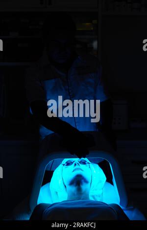 Woman getting facial treatment with led therapy Stock Photo - Alamy