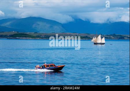 The Coastal Connection boat passes the Bessie Ellen tall ship in Oban ...
