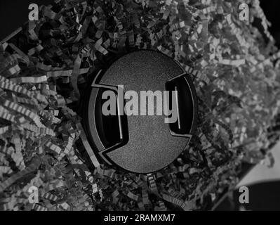 Black camera lens cap on the black textured table. Flat lay with copy space for text Stock Photo ...