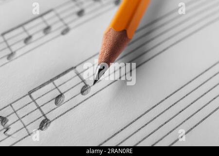 Sheet with musical notes and pencil, closeup view Stock Photo - Alamy