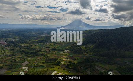 Aerial view of active volcano Sinabung with clouds and smoke. Sumatra ...