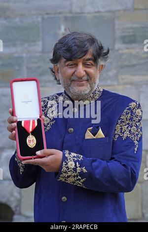 Professor Sir Aziz Sheikh with his knighthood following an investiture ...