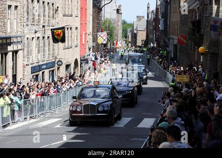 The motorcade of Britain's King Charles III drives along the Royal Mile ...