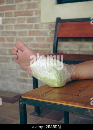 woman feet wrapped in cabbage leaves compress for anti inflammatory ...