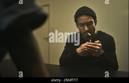 Man, suspect smoking and detective in interrogation room with criminal ...