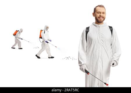 Team of pest control professionals in white suits spraying cockroaches ...