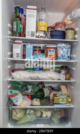 messy fridge full of half empty plates and expired food Stock Photo - Alamy
