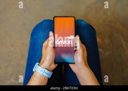 In this photo illustration, the Devon Energy logo is displayed on a ...