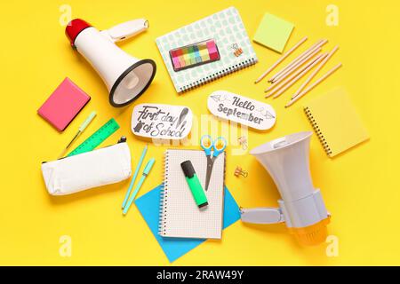 Stationery, megaphone, sheets with text HELLO SEPTEMBER and FIRST DAY ...
