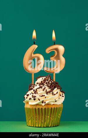 Birthday candle number 63 - Anniversary cupcake on black background ...
