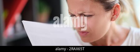Concentrated female read papers, squinting to see more clearly Stock ...