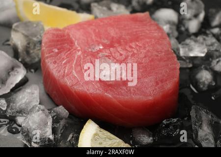 Raw tuna fillet and ice cubes on dark table, closeup Stock Photo - Alamy