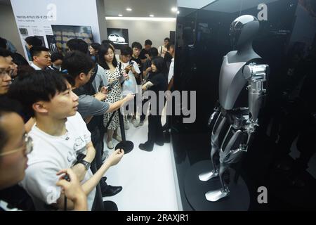 SHANGHAI, CHINA - JULY 6, 2023 - Spectators look at Tesla's humanoid ...
