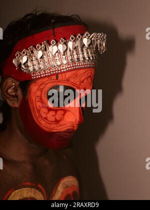 The mask of a theyyam performing an ancient trance ritual at a local ...