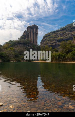 A rock cliff lining the nine bend river or Jiuxi in Wuyishan or Mount ...