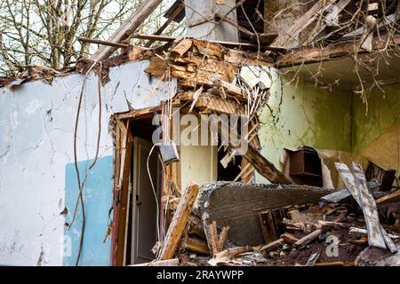 Demolition of an old two-story wooden house. Half destroyed building ...