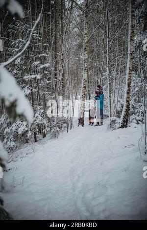 Child running in snowy forest. Toddler kid playing outdoors. Kid play ...