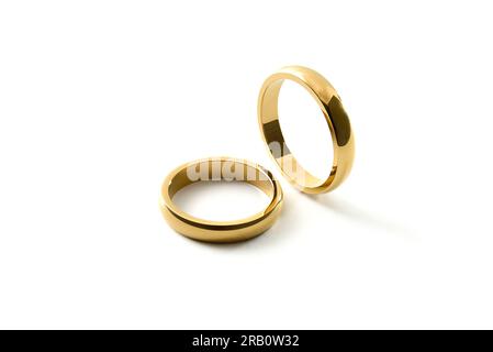 Detail of engagement gold rings standing next to each other on white ...