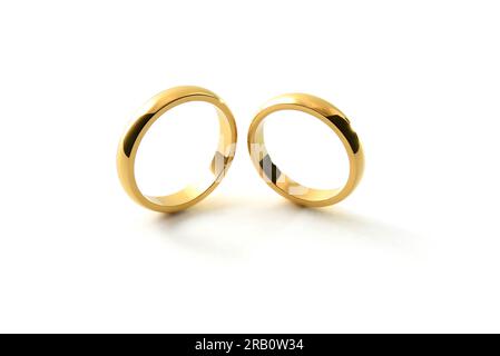 Detail of engagement gold rings standing perpendicular to each other on ...