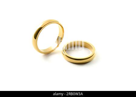 Detail of engagement gold rings standing next to each other on white ...