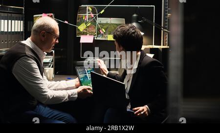 Private investigator gathering evidence from case files and classified ...