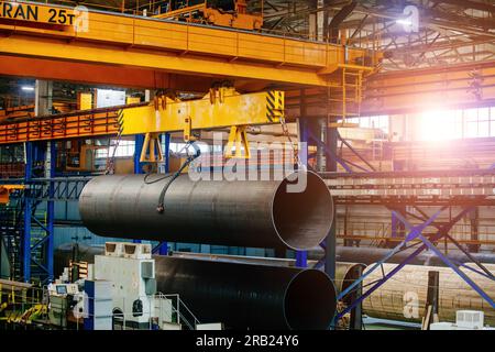 Finished pipe transportation by overhead crane in pipe factory Stock ...