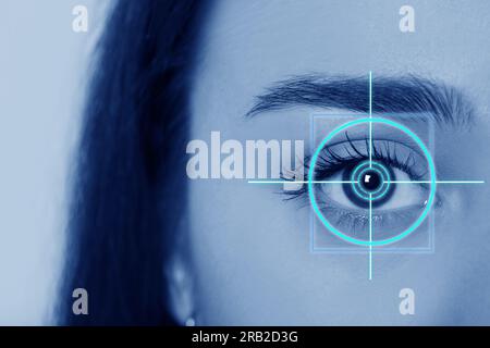 Vision test chart and laser reticle focused on man's eye against light ...