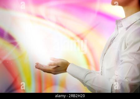 Aura phenomena. Woman with flows of energy and lights around her hand ...