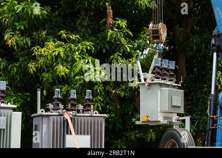 crane hook lifts up the distribution transformer Stock Photo - Alamy
