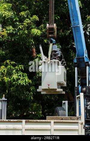 crane hook lifts up the distribution transformer Stock Photo - Alamy