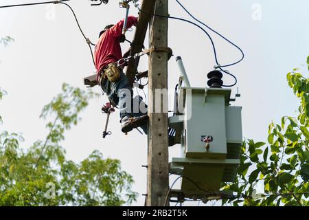 worker install a three-phase current transformer with crane on the ...