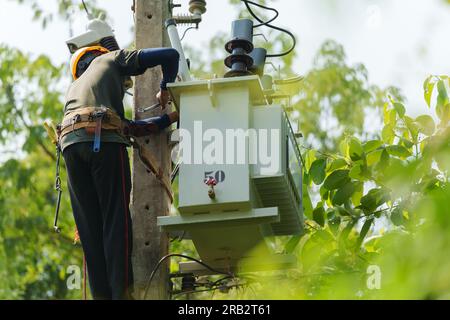worker install a three-phase current transformer with crane on the ...