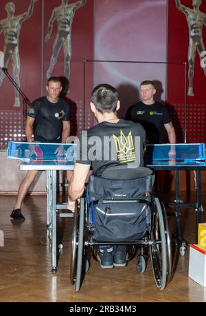 KYIV, UKRAINE - Jul. 05, 2023: A man in a wheelchair is seen playing ...