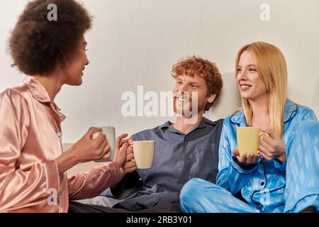 open relationship, polygamy concept, three interracial lovers blowing ...