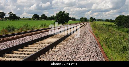Lineside view of a double track railway line, as seen from a public ...