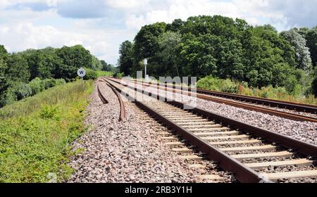 Lineside view of a double track railway line, as seen from a public ...