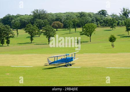 Tiger Moth plane taxiing on grass airstrip at wings & wheels event in ...