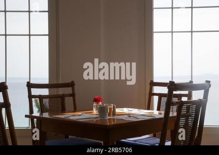 Empty seats and tables before dinner time in the indoor restaurant ...