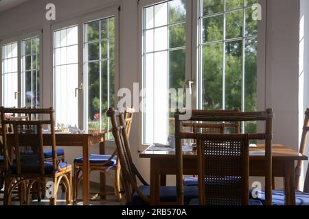 Empty seats and tables before dinner time in the indoor restaurant ...