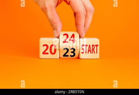 2024 restart new year symbol. Businessman turns a wooden cube and ...