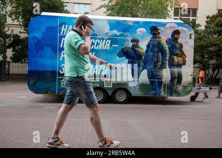 A man walks past an ad for military submarines in the downtown core ...