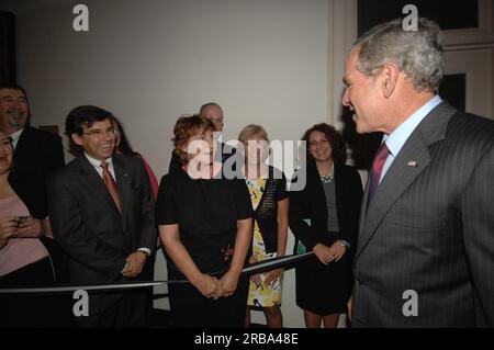 Department staff greeting President George W. Bush, from behind rope ...