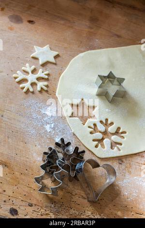 Christmas bakery, short pastry is rolled out on a baking board, cookie ...