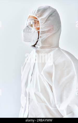 Cropped doctor in protective uniform and latex gloves vaccinating ...