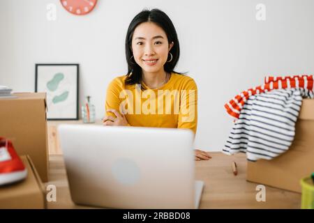 Online small business owner cute blonde woman scans a barcode-labeled ...