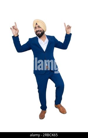 Excited young indian sikh man wearing blue suit and turban screaming ...