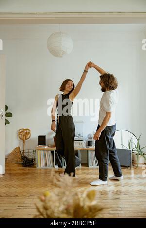 Lovely couple dancing together indoors Stock Photo - Alamy
