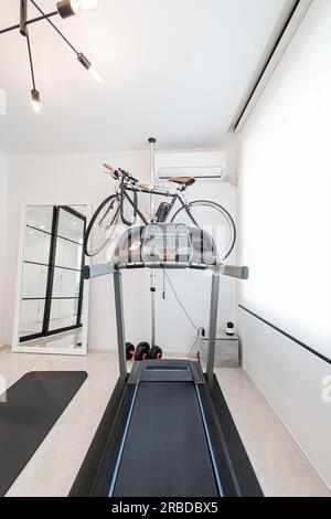 Interior of living room with modern treadmill Stock Photo - Alamy