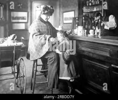 Mother giving her child beer in a pub, Victorian period Stock Photo - Alamy